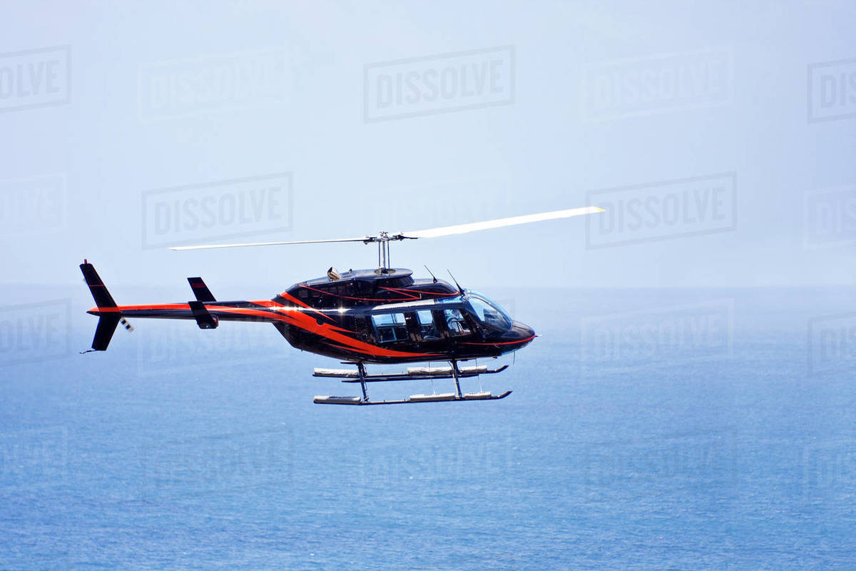 Side view of flying helicopter - Royalty-free Stock Photo | Dissolve