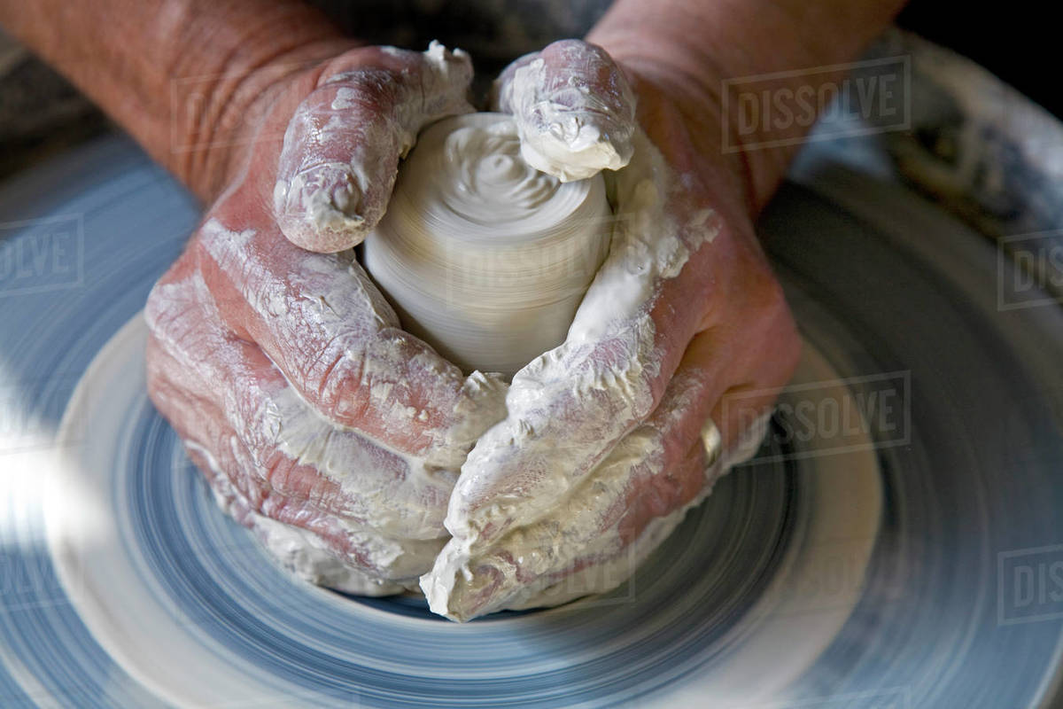 Person's hands making pottery - Stock Photo - Dissolve
