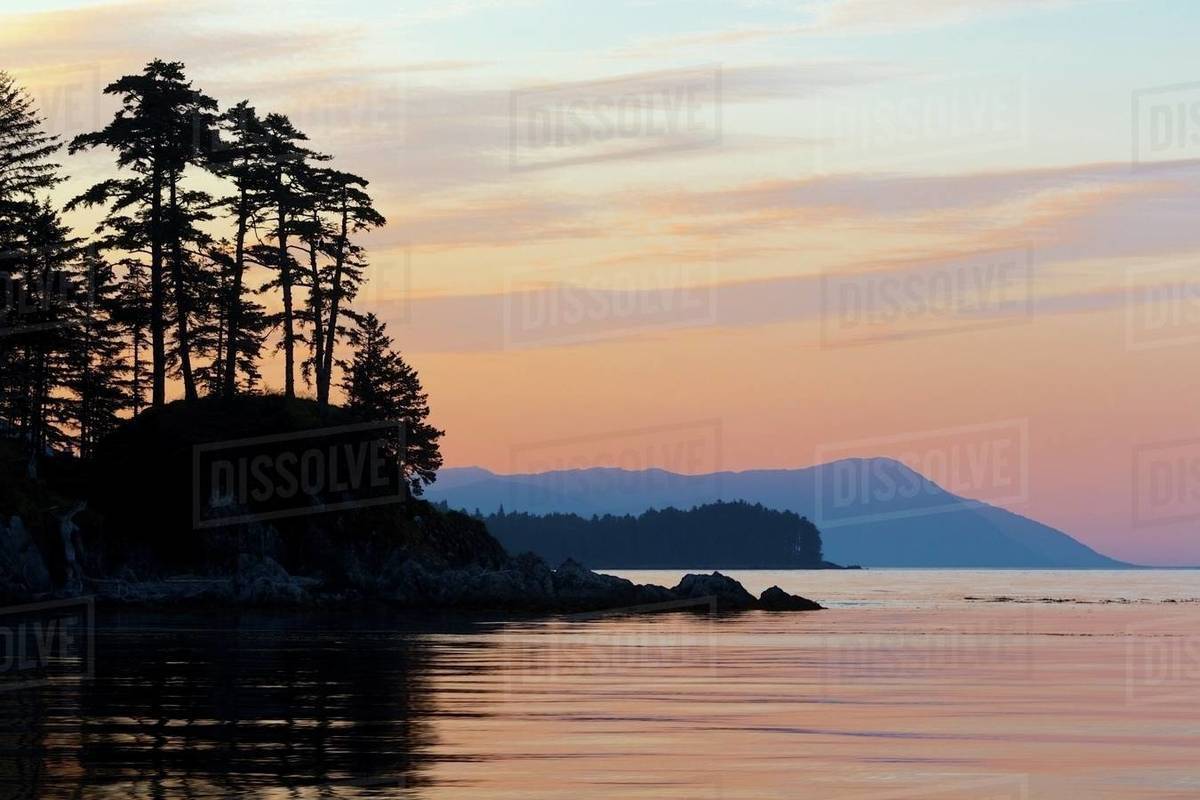 Silhouette of trees on an island, Basket Bay, Tenakee Springs, Alaska ...