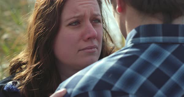 A woman looks up at man with a disappointed look on her face - 4K ...