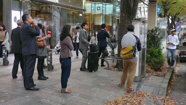 People smoking cigarette in the street, Asian smokers in smoking spot ...