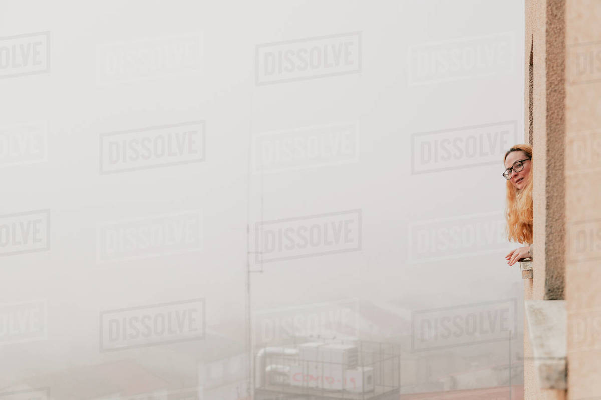 Quarantined woman bending over the window watching outside - Stock ...