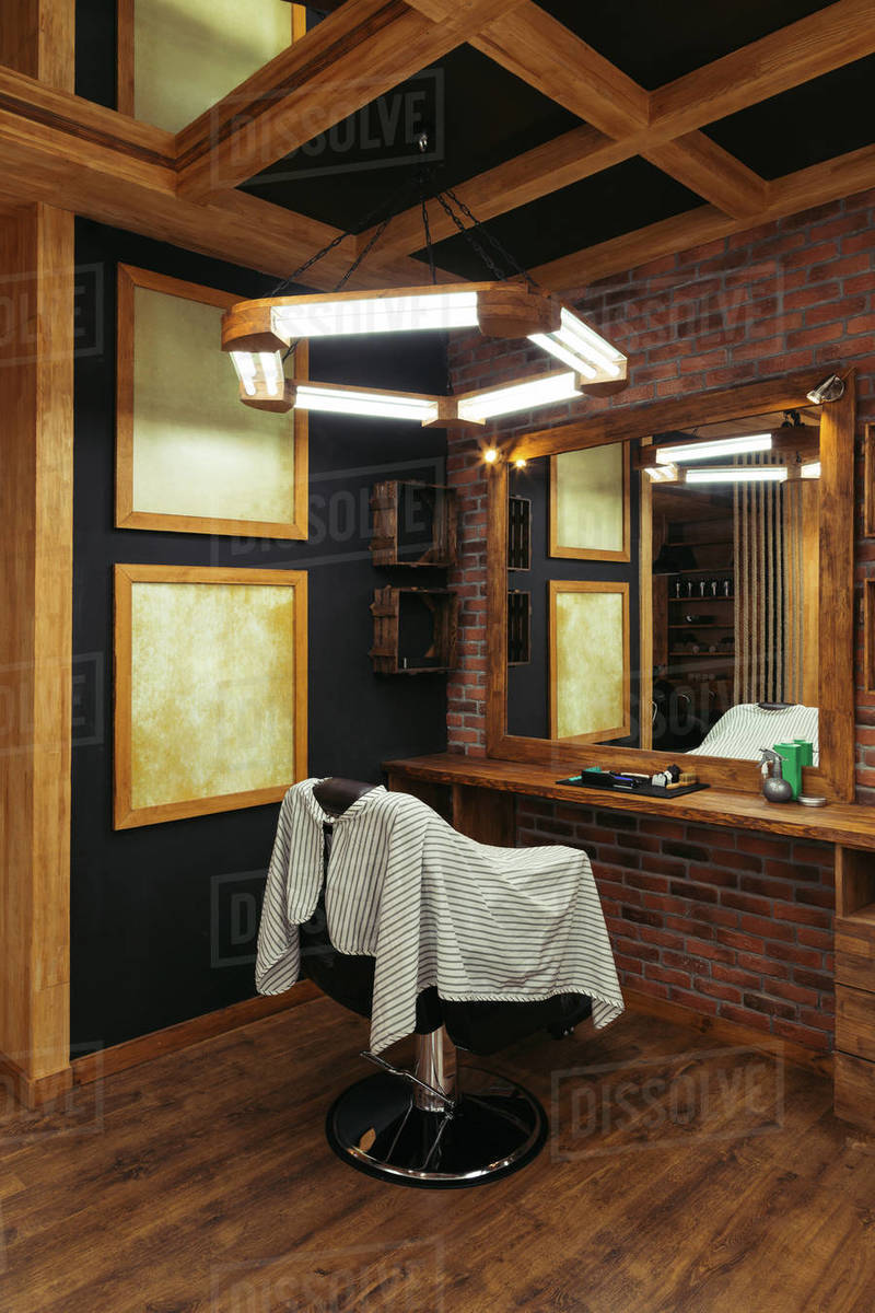 Modern empty barbershop interior with chair, mirror and lamps - Royalty ...