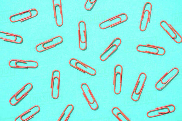 Full frame of arranged red paper clips on blue background - Royalty ...