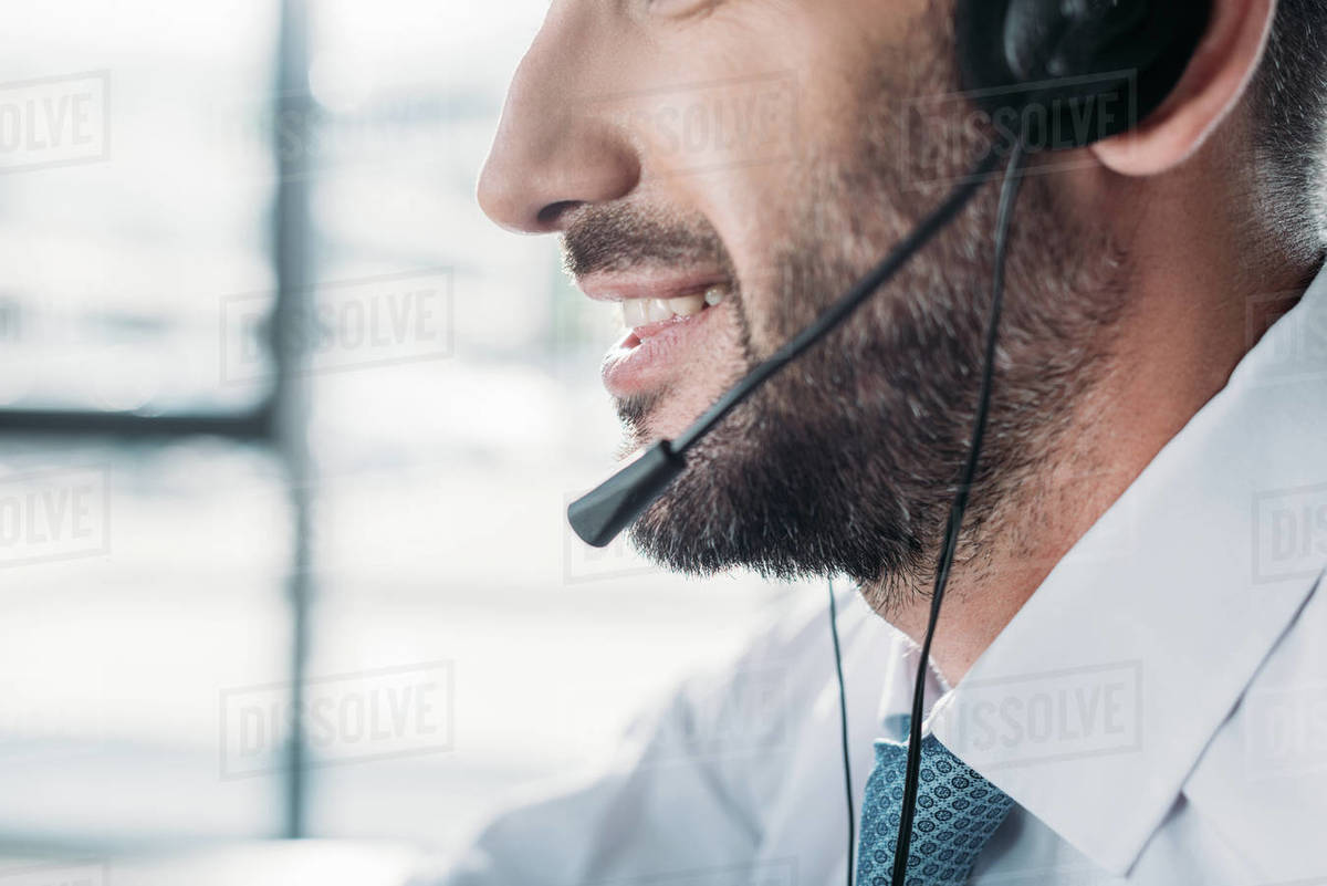Cropped shot of happy support hotline worker in white shirt at work ...