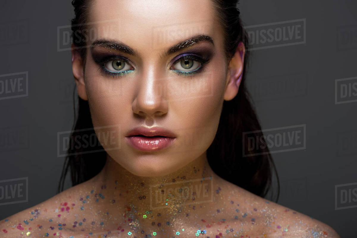 Beautiful glamorous young woman posing with glitter on body, isolated ...
