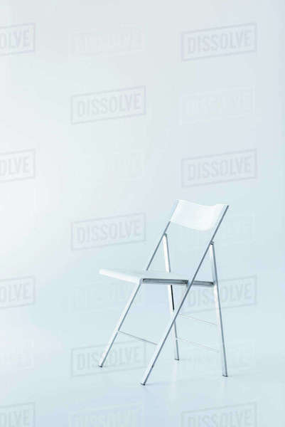 One white chair, isolated on white with copy space - Stock Photo - Dissolve