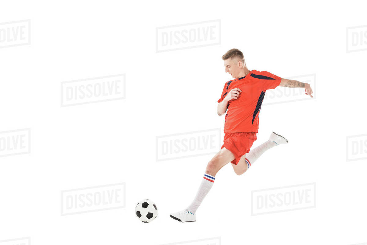 full length view of young sportsman playing soccer isolated on white ...