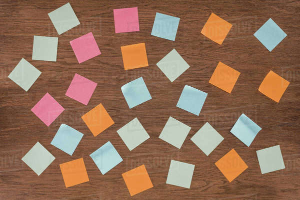 Top view of arranged colorful post it notes on wooden table - Royalty ...