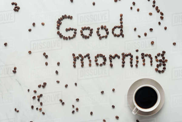 top view of cup of delicious coffee and good morning lettering made of ...