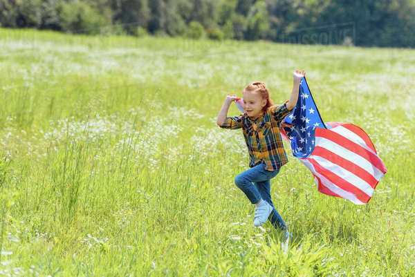 child running in field with american flag in hands - Royalty-free Stock ...