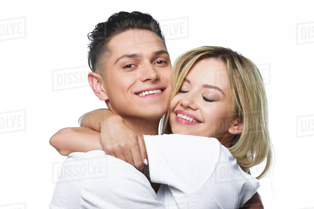 Portrait of happy affectionate couple cuddling isolated on white ...