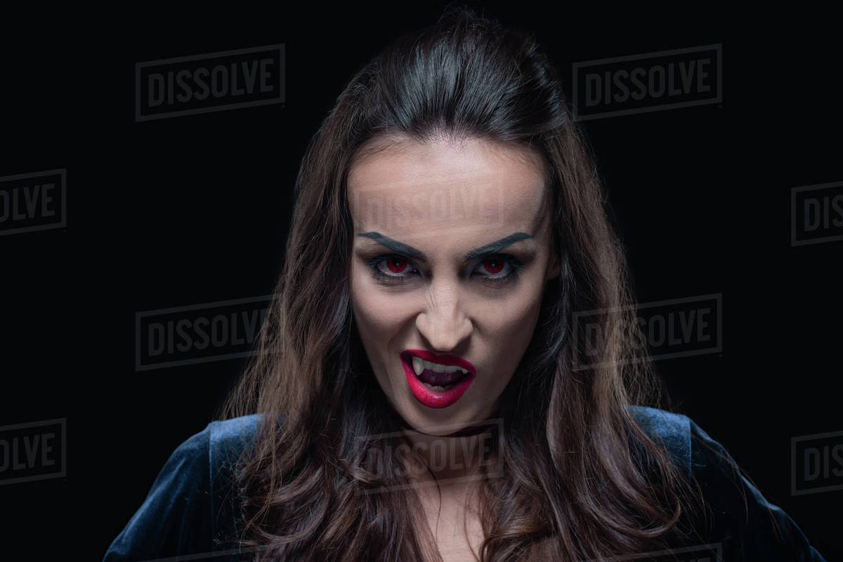 Horror woman showing vampire fangs isolated on black - Royalty-free ...