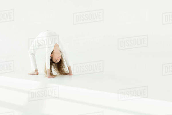 Cute preteen girl doing bridge exercise on white - Royalty-free Stock ...