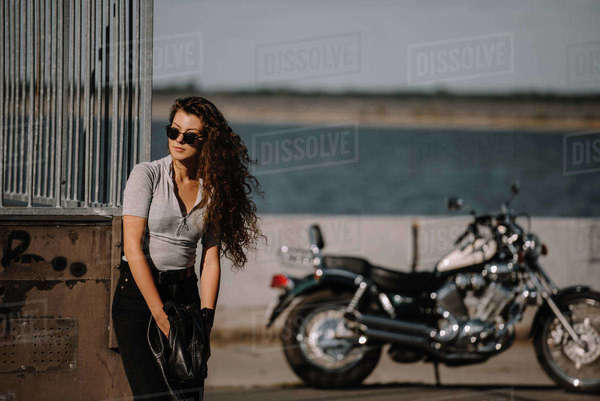 Beautiful girl in sunglasses posing on quay with cruiser motorcycle on ...