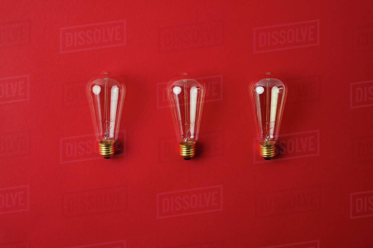 top view of row of vintage incandescent lamps on red tabletop - Royalty ...