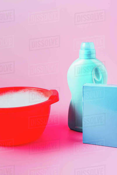 close up view of washing powder, laundry liquid and plastic basin with ...
