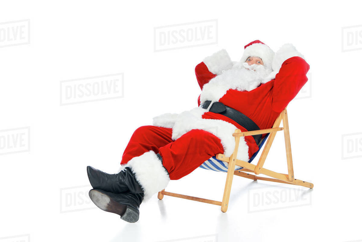 happy santa claus relaxing on beach chair on white - Royalty-free Stock ...