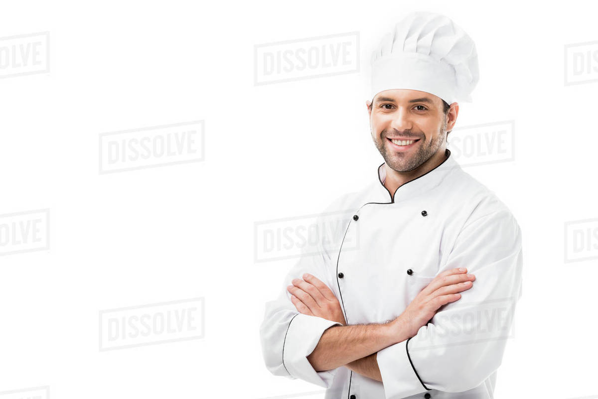 Attractive young chef with crossed arms looking at camera isolated on ...