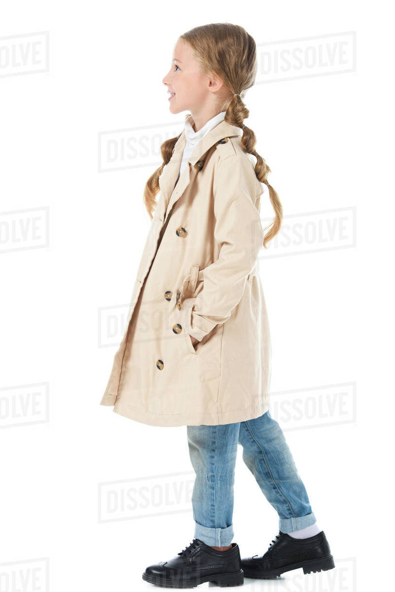 Side view of child posing in autumn beige coat, isolated on white ...