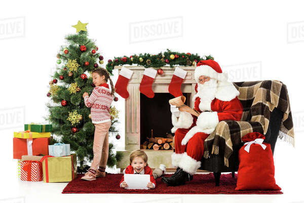 Happy kids and santa looking at camera while spending time together ...