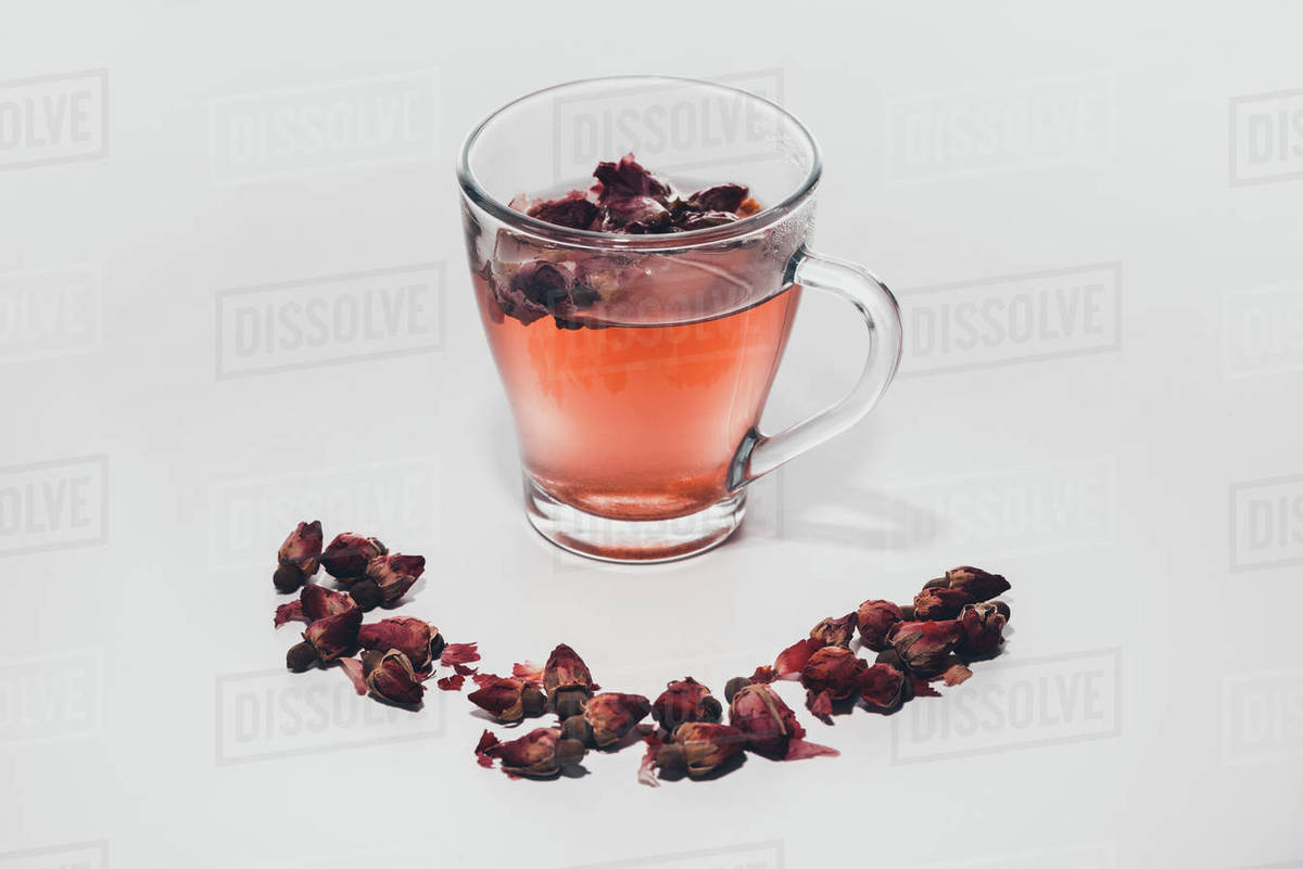 Dried rose buds tea in cup on white tabletop - Royalty-free Stock Photo ...