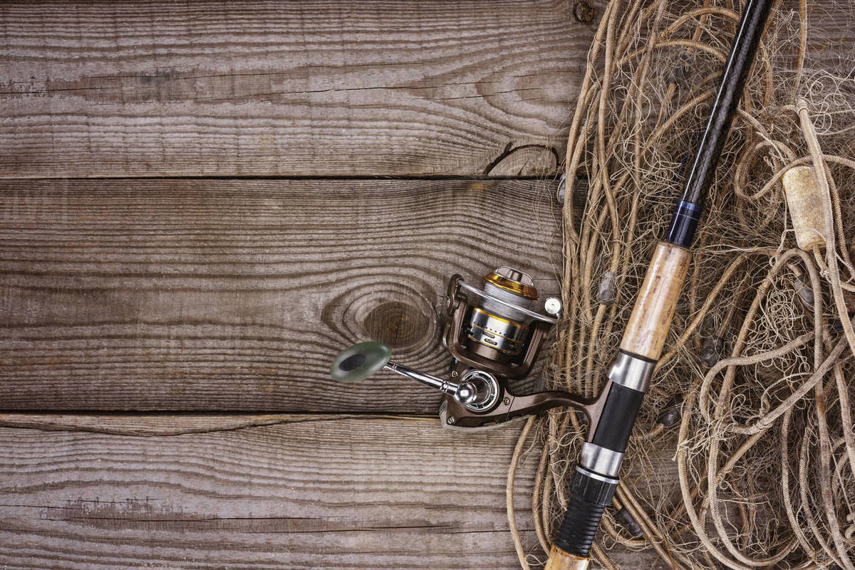 Top view of fishing net and fishing rod on wooden planks - Royalty-free ...