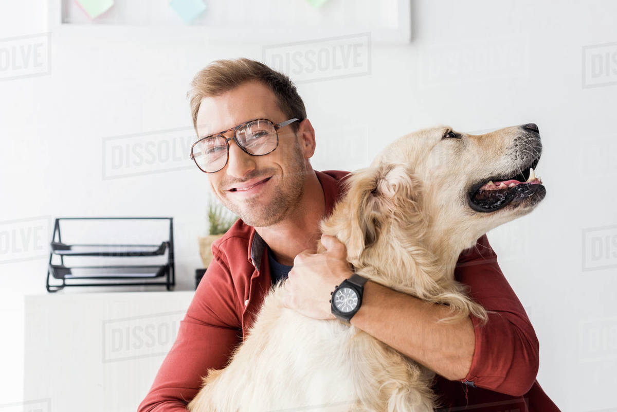 Smiling man hugging golden retriever dog - Royalty-free Stock Photo ...