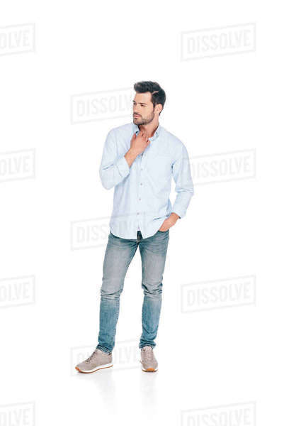 full length view of handsome young man standing with hand in pocket and ...