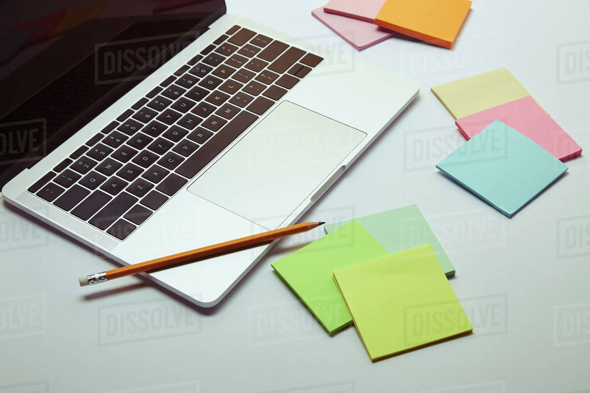 Laptop, paper stickers and pencil on white tabletop - Royalty-free ...