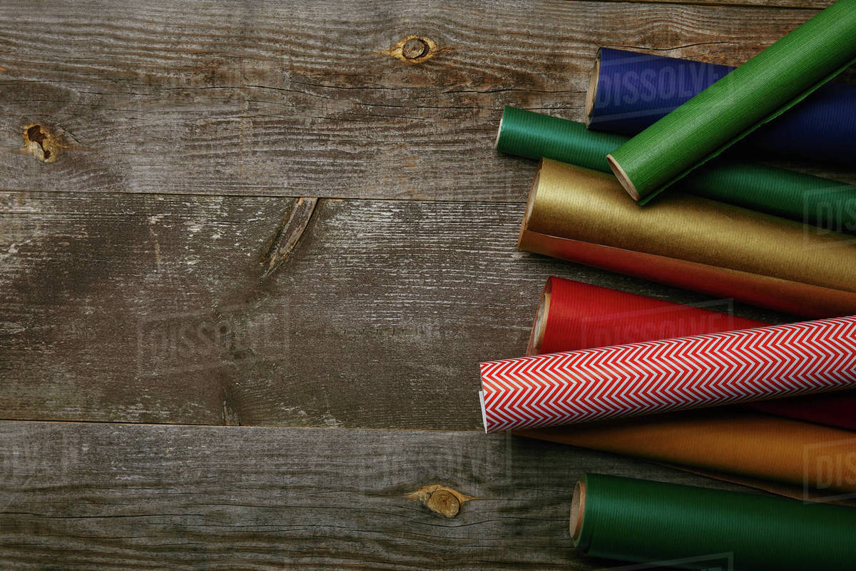 Top view of arranged wrapping papers of different colors on wooden ...