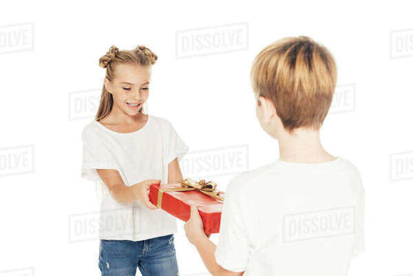 Boy presenting gift box to happy friend isolated on white - Royalty ...