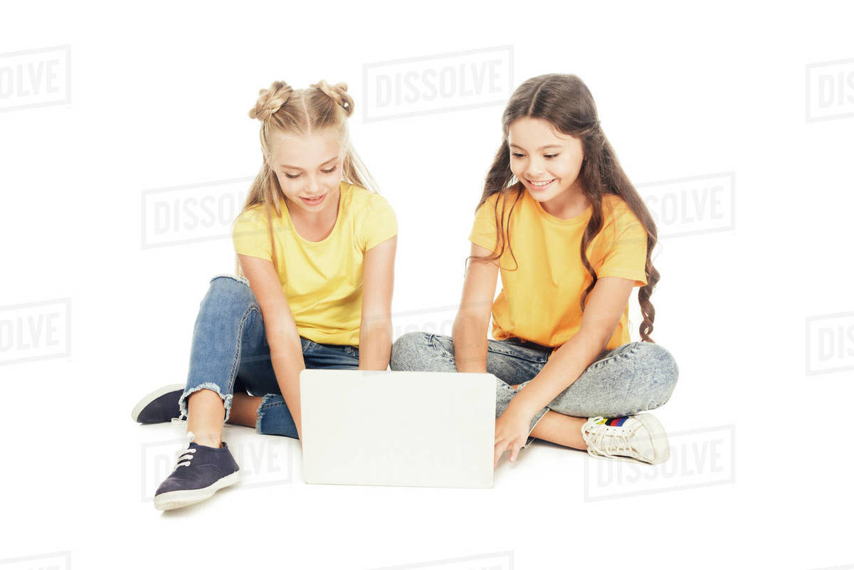 Beautiful smiling kids using laptop together isolated on white ...