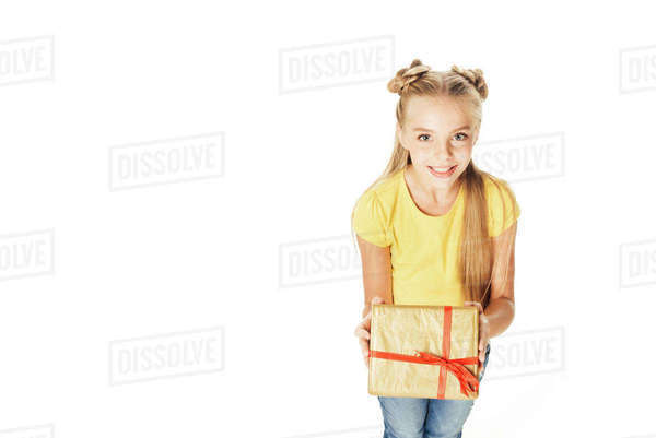 High angle view of beautiful happy child holding present and smiling at ...