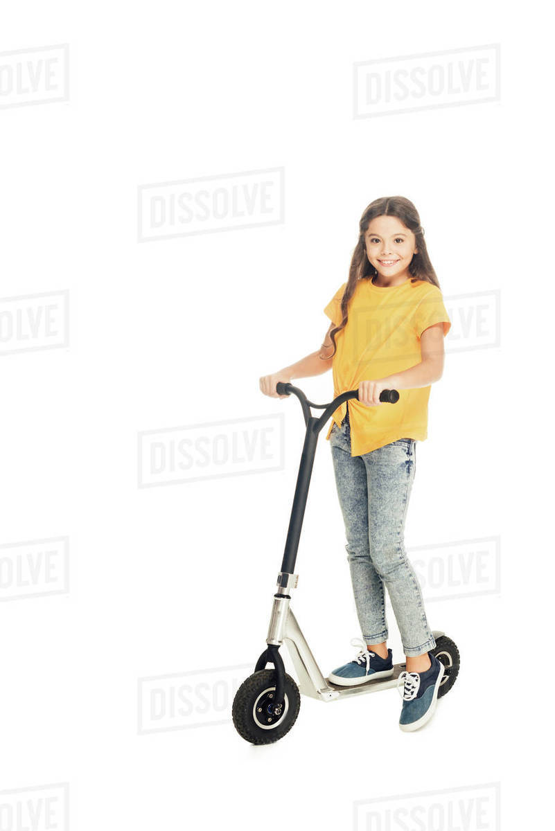 Adorable happy child riding scooter and smiling at camera isolated on ...