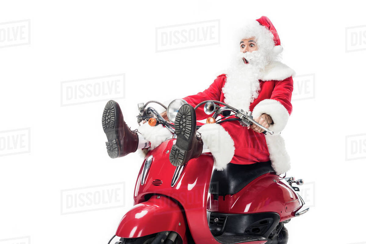 Shocked Santa Claus in costume riding on scooter isolated on white ...