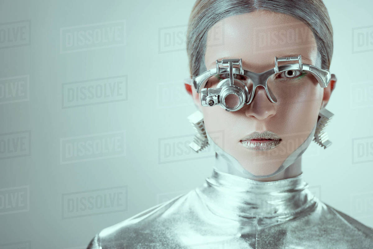 Close-up view of silver robot looking at camera isolated on grey ...