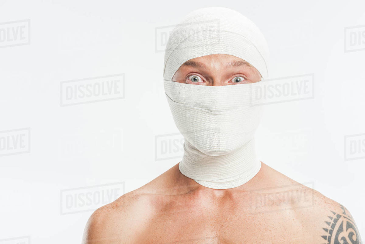 Close up of man face covered with white bandages after plastic surgery ...