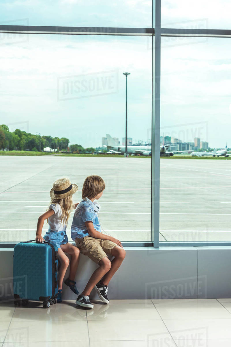 Little kids looking out window together in airport - Royalty-free Stock ...