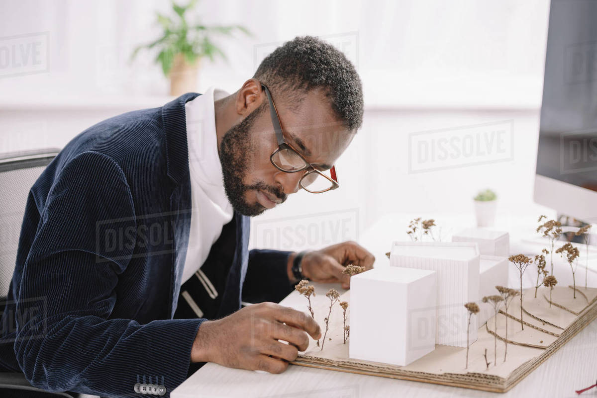 Professional concentrated African American architect working with ...