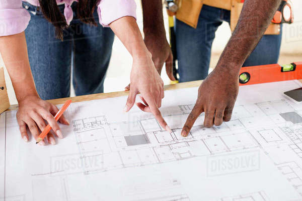 Cropped shot of couple pointing at building plan while making ...