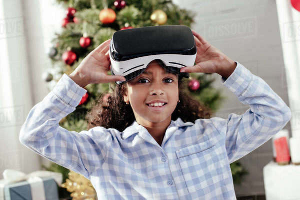 african american child in pajamas using virtual reality headset and ...