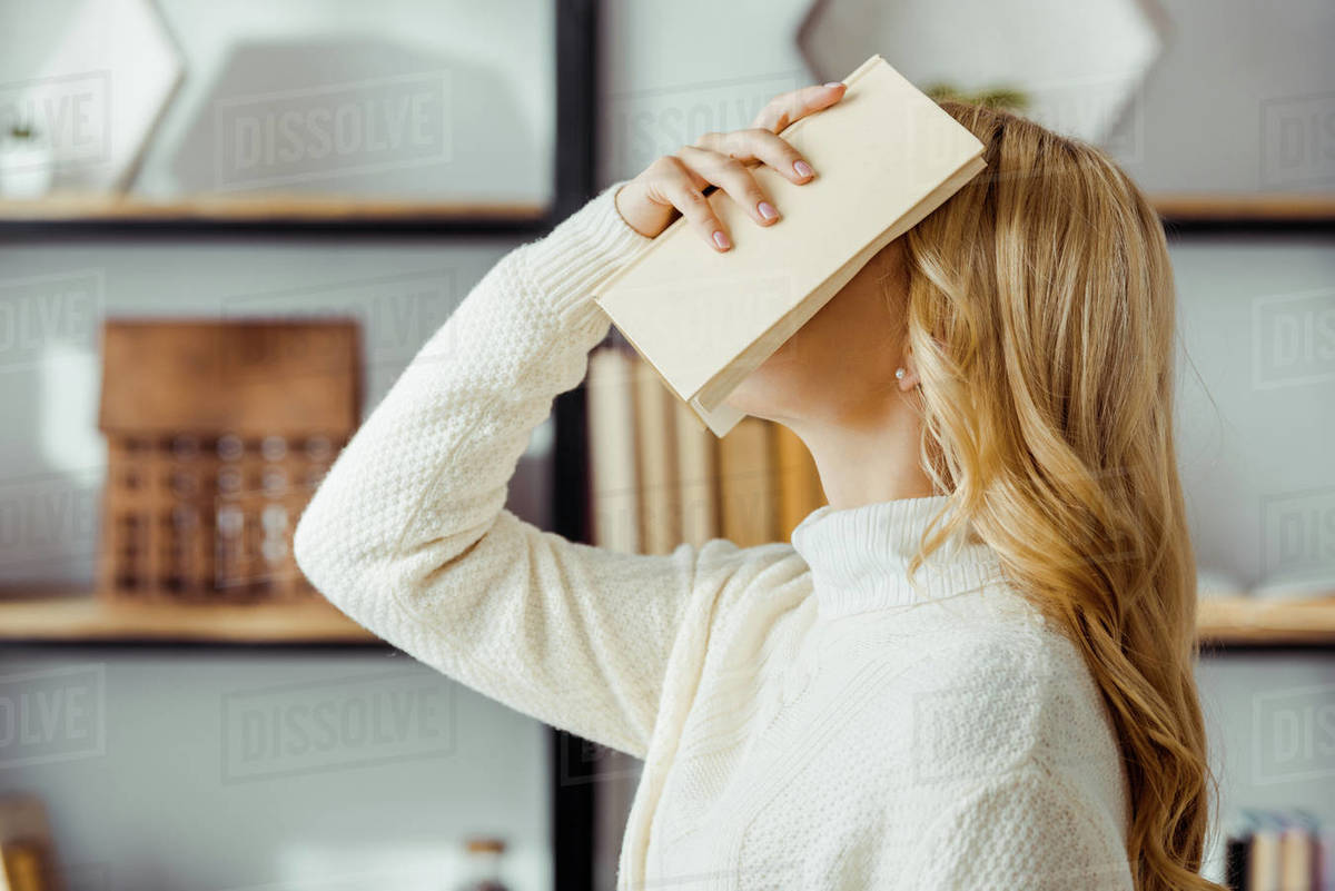 close up of blonde woman putting book on face - Royalty-free Stock ...