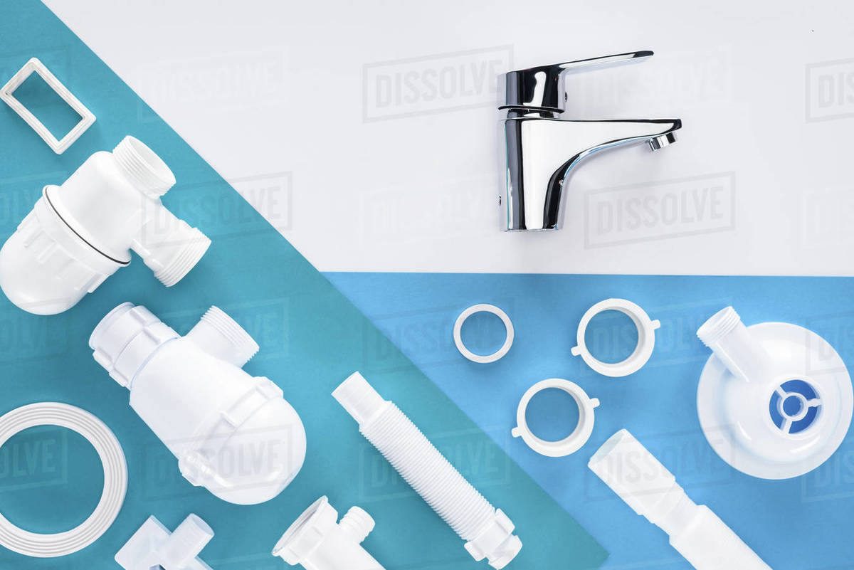 top view of plastic plumbing pieces and water mixer isolated on white ...