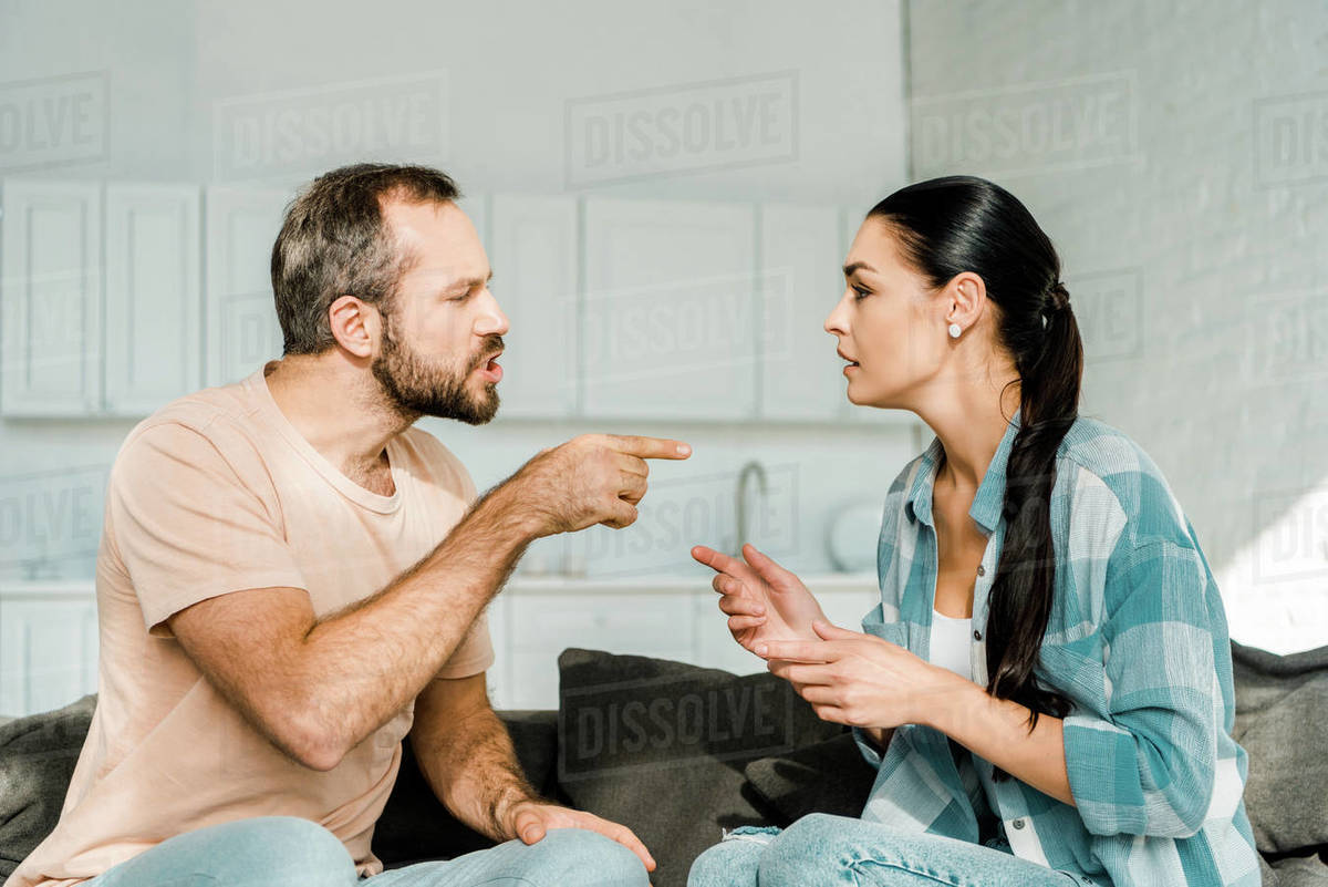 Couple having argument and husband yelling at wife at home - Royalty ...