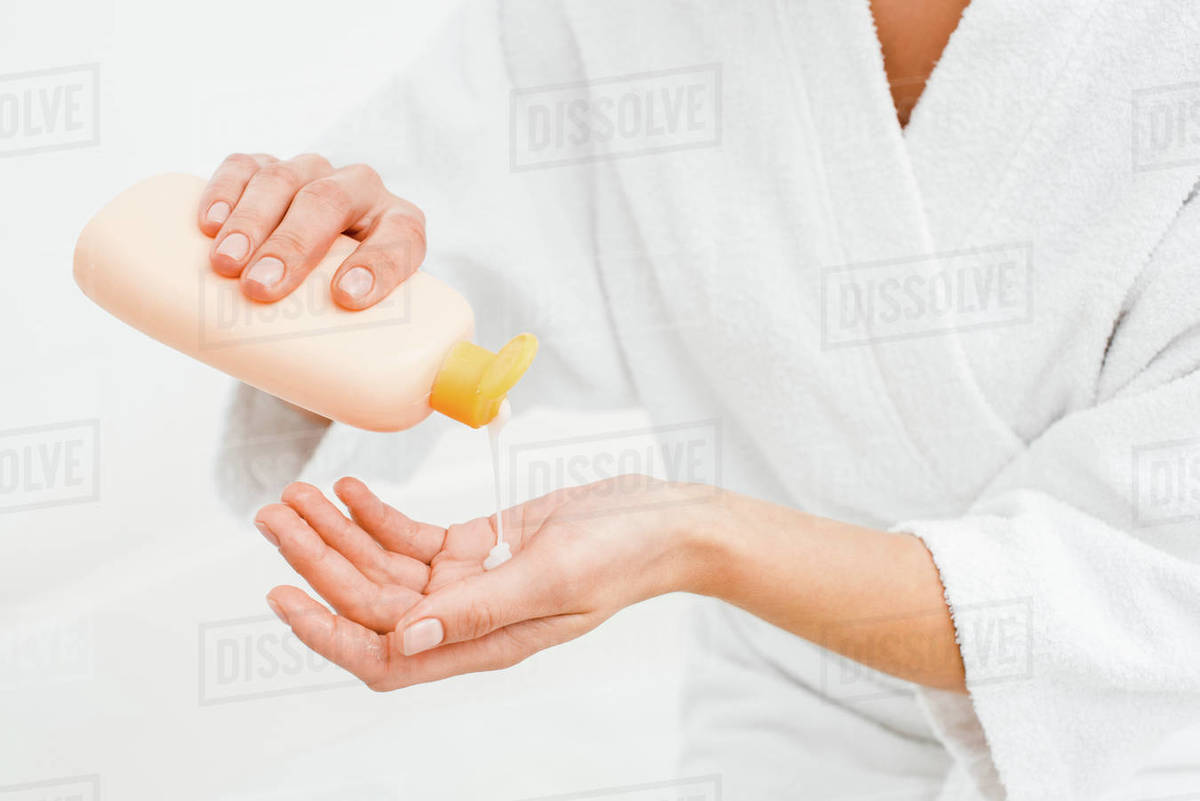 Close up of woman squeezing lotion in hand isolated on white - Stock ...