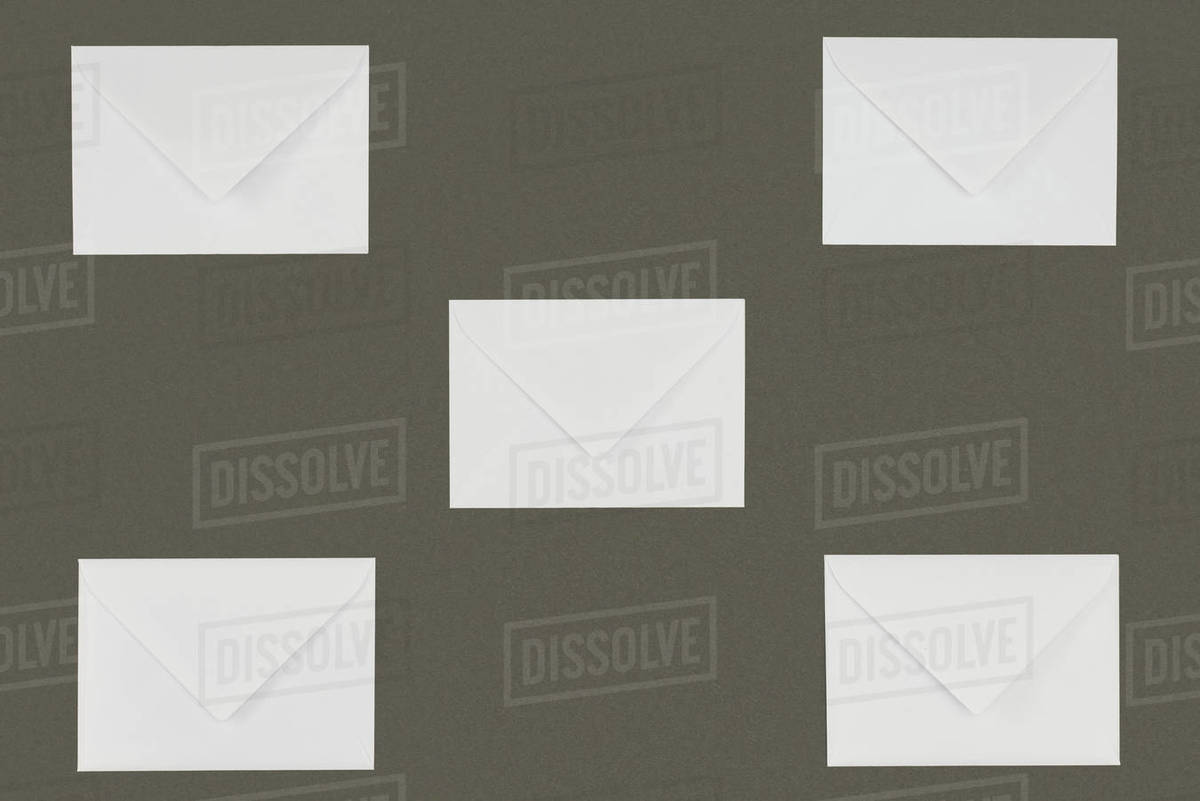 close-up view of closed white envelopes isolated on grey background ...