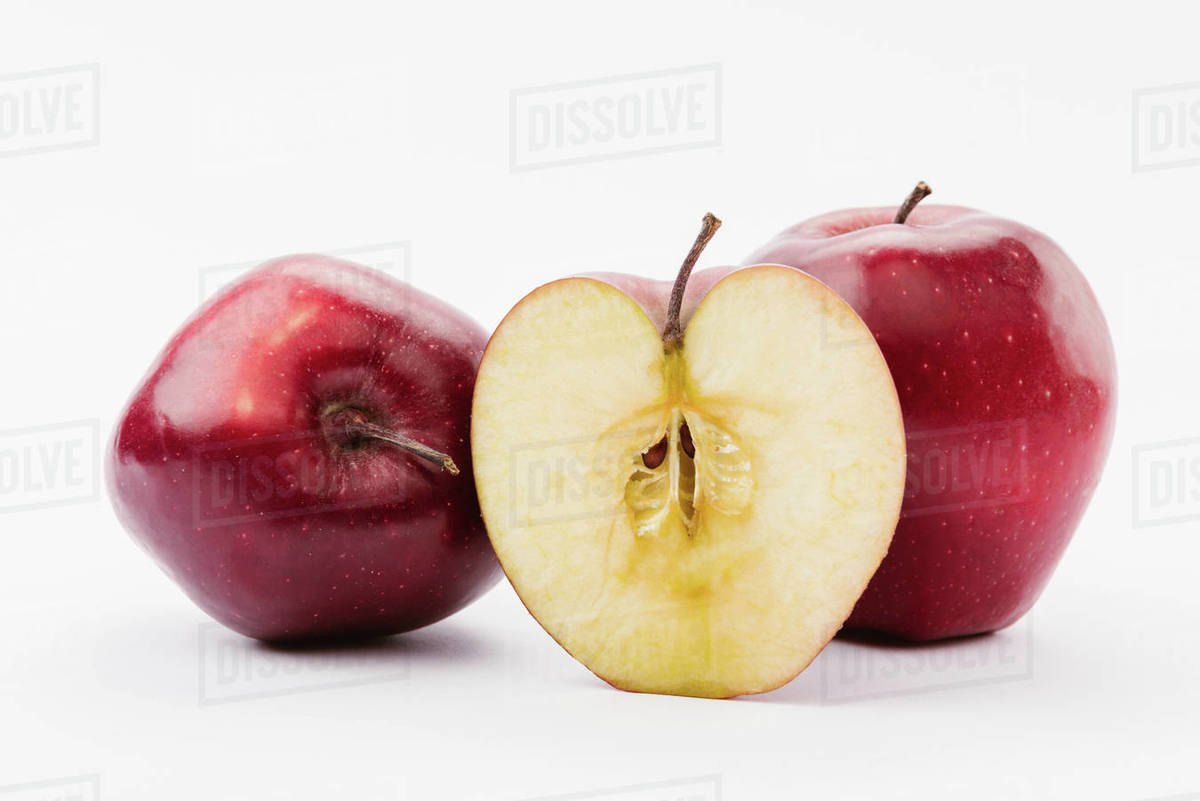 cut and whole red delicious apples on white background - Stock Photo ...