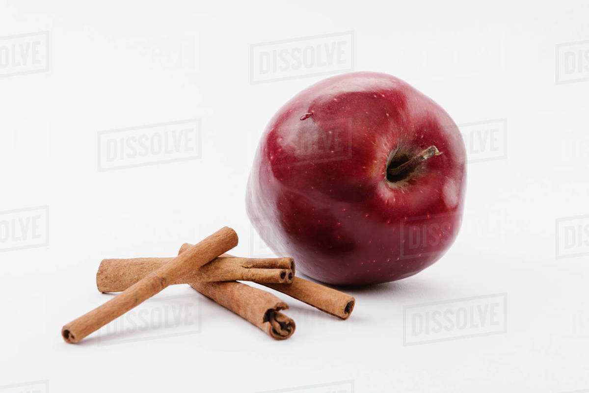large red delicious apple and cinnamon on white background - Stock ...