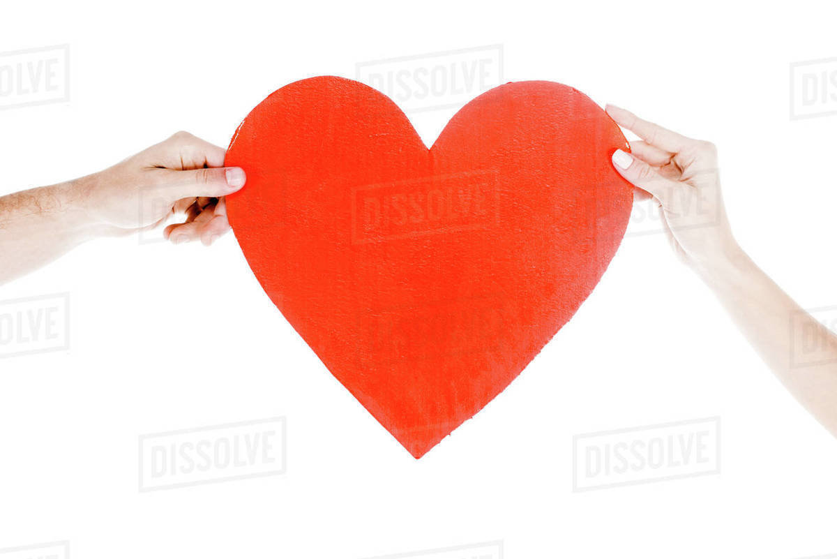 Partial view of people holding big red heart isolated on white - Stock ...
